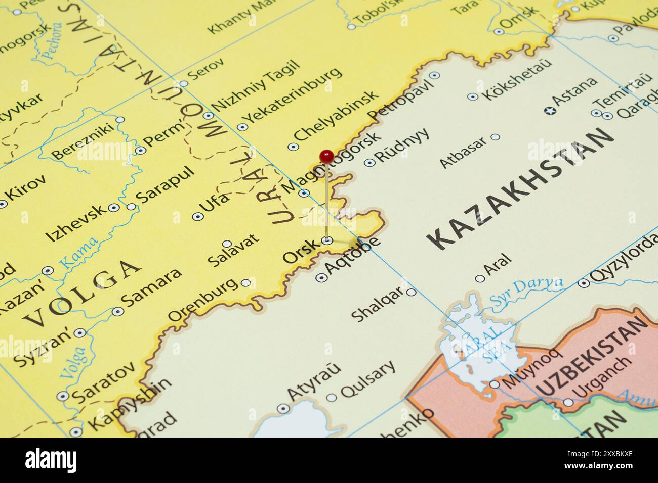 Close up to a Orsk city with a red pin needle into Russia country ...
