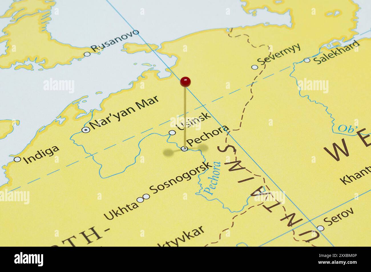 Close up to a Pechora city with a red pin needle into Russia country ...