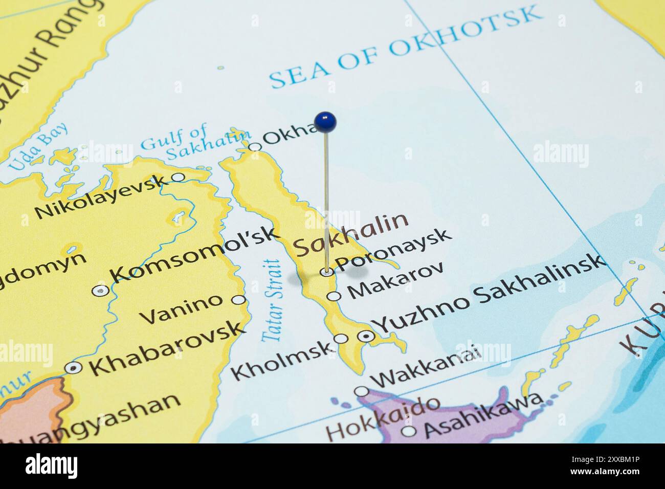Close up to a Poronaysk city with a blue pin needle into Russia country ...