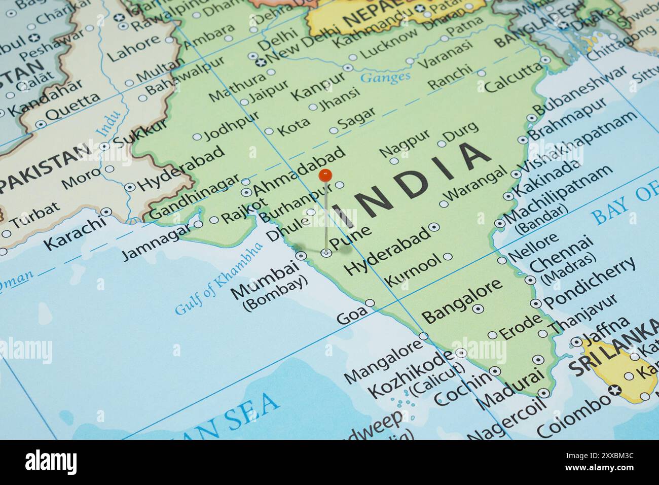 Close up to a Pune city with an orange pin needle into India country ...