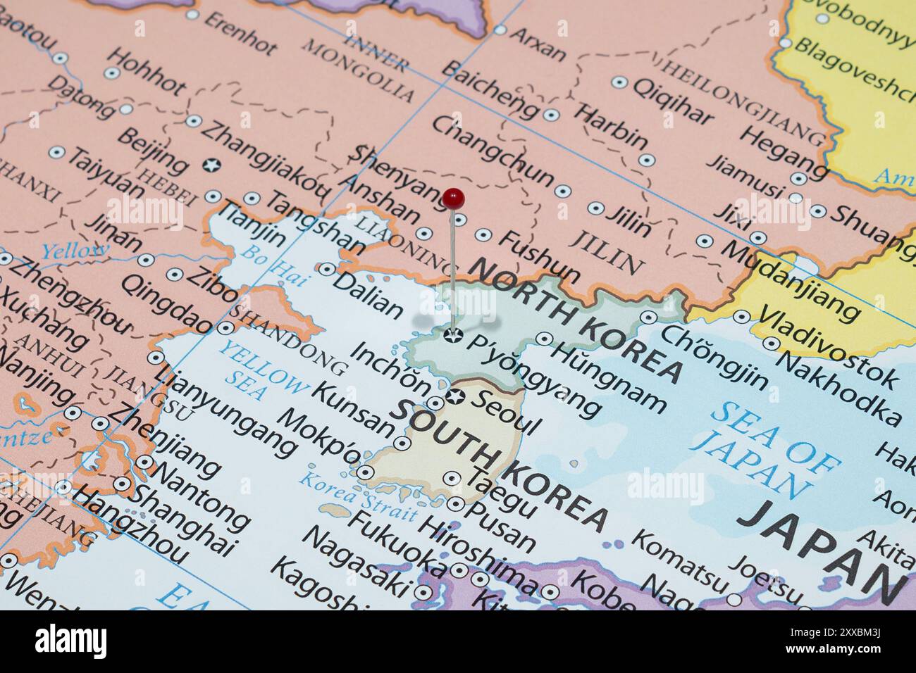 Close up to a Pyongyang city with a red pin needle into North Korea ...