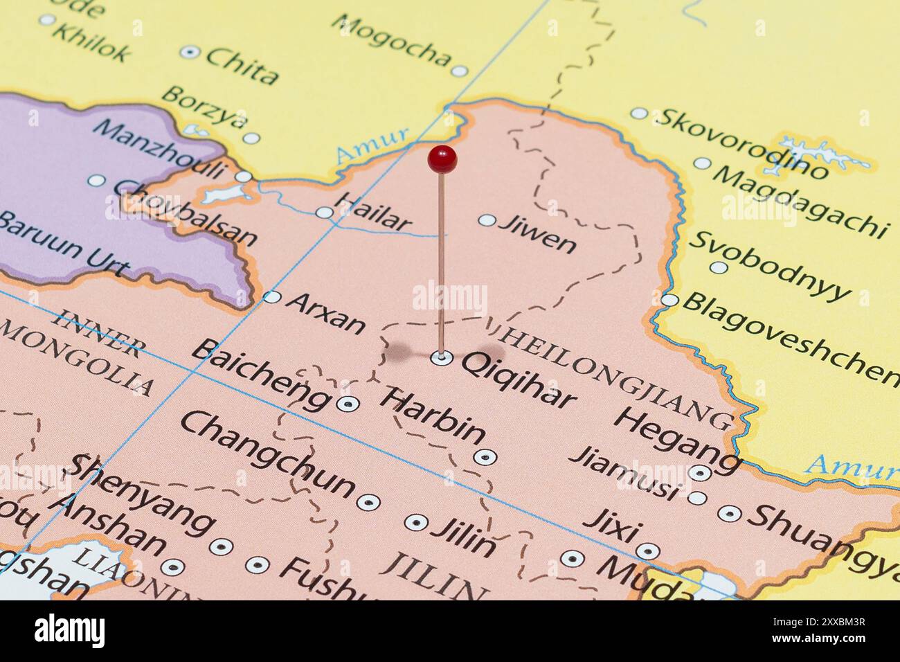 Close up to a Qiqihar city with a red pin needle into China country ...