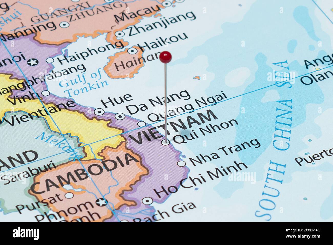 Close up to a Qui Nhon city with a red pin needle into Vietnam country ...