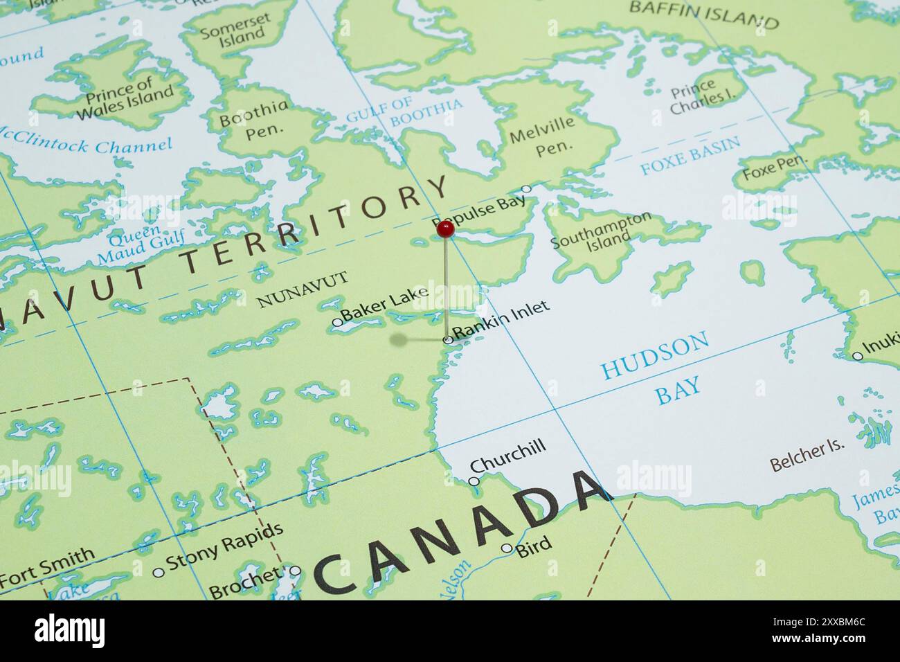 Close up to a Rankin Inlet city with a red pin needle into Canada ...