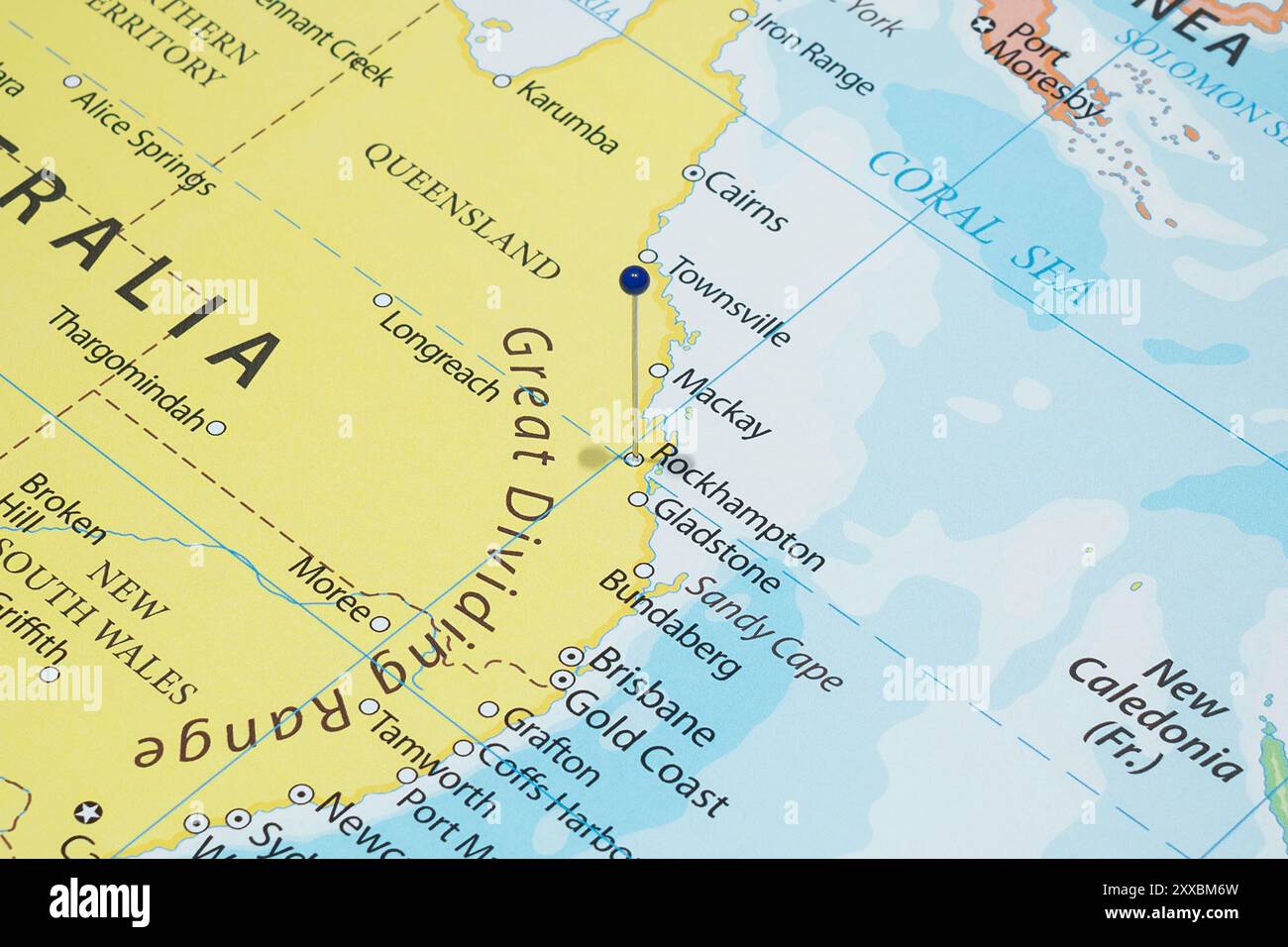 Close up to a Rockhampton city with a blue pin needle into Australia ...