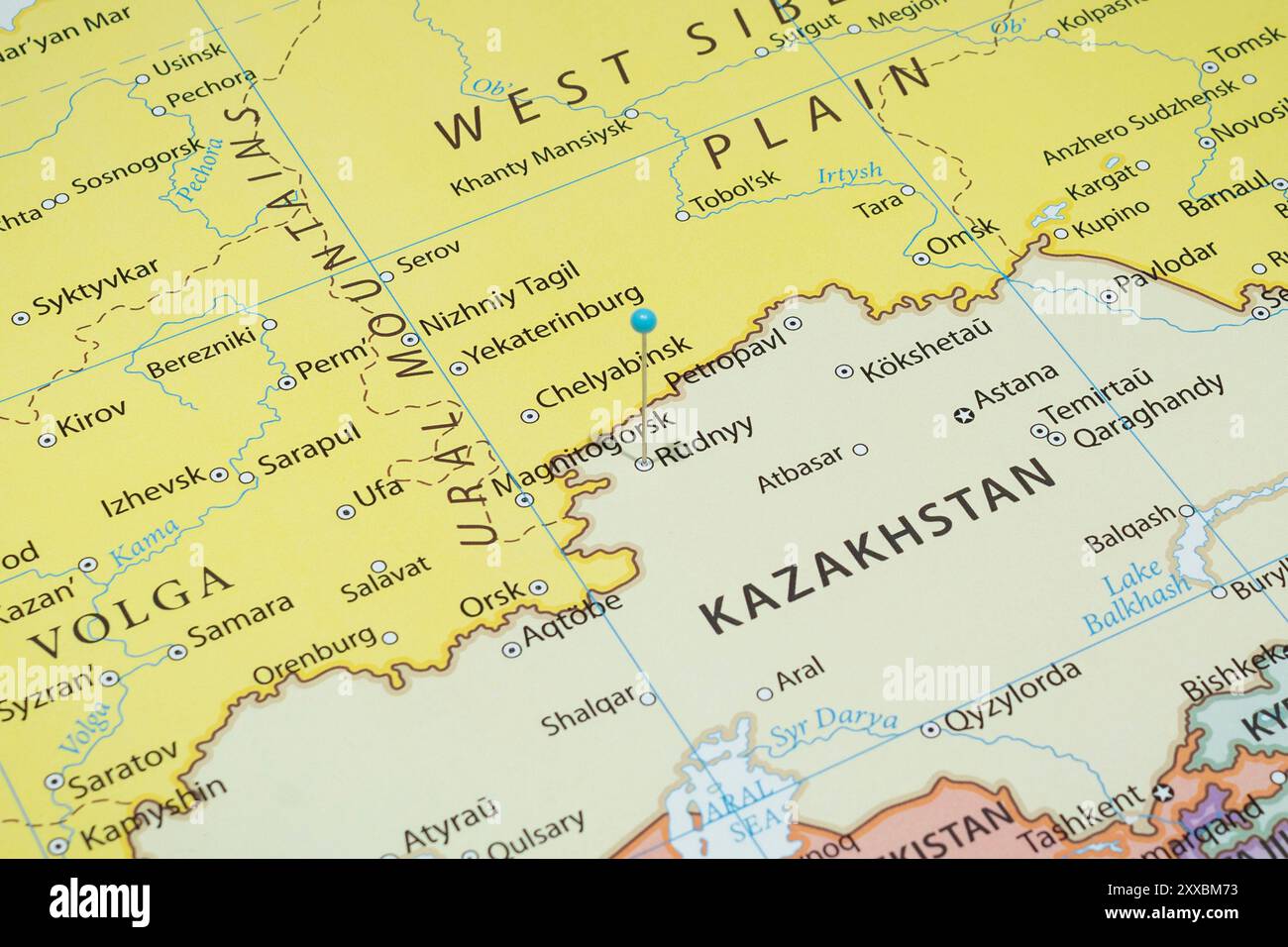 Close up to a Rudny city with a light blue pin needle into Kazakhstan ...
