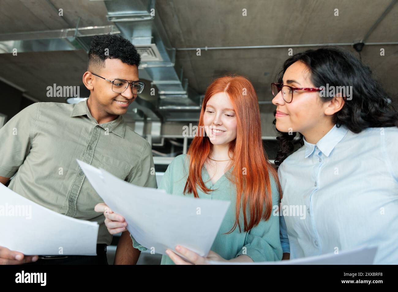 Group of colleagues exchanging ideas on business strategies holding ...