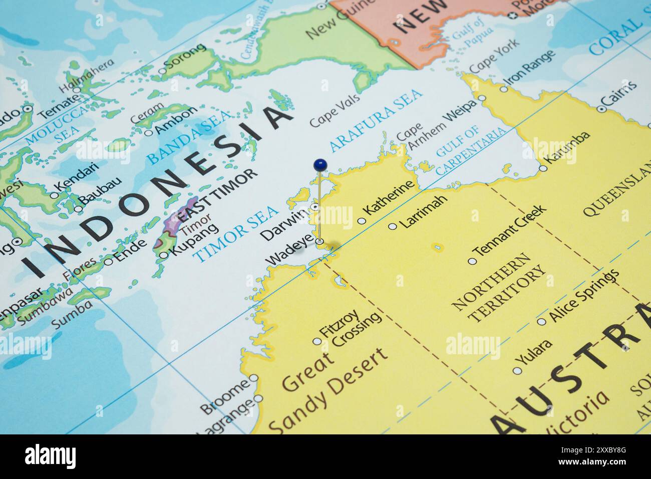 Close up to a Wadeye city with a blue pin needle into Australia country ...