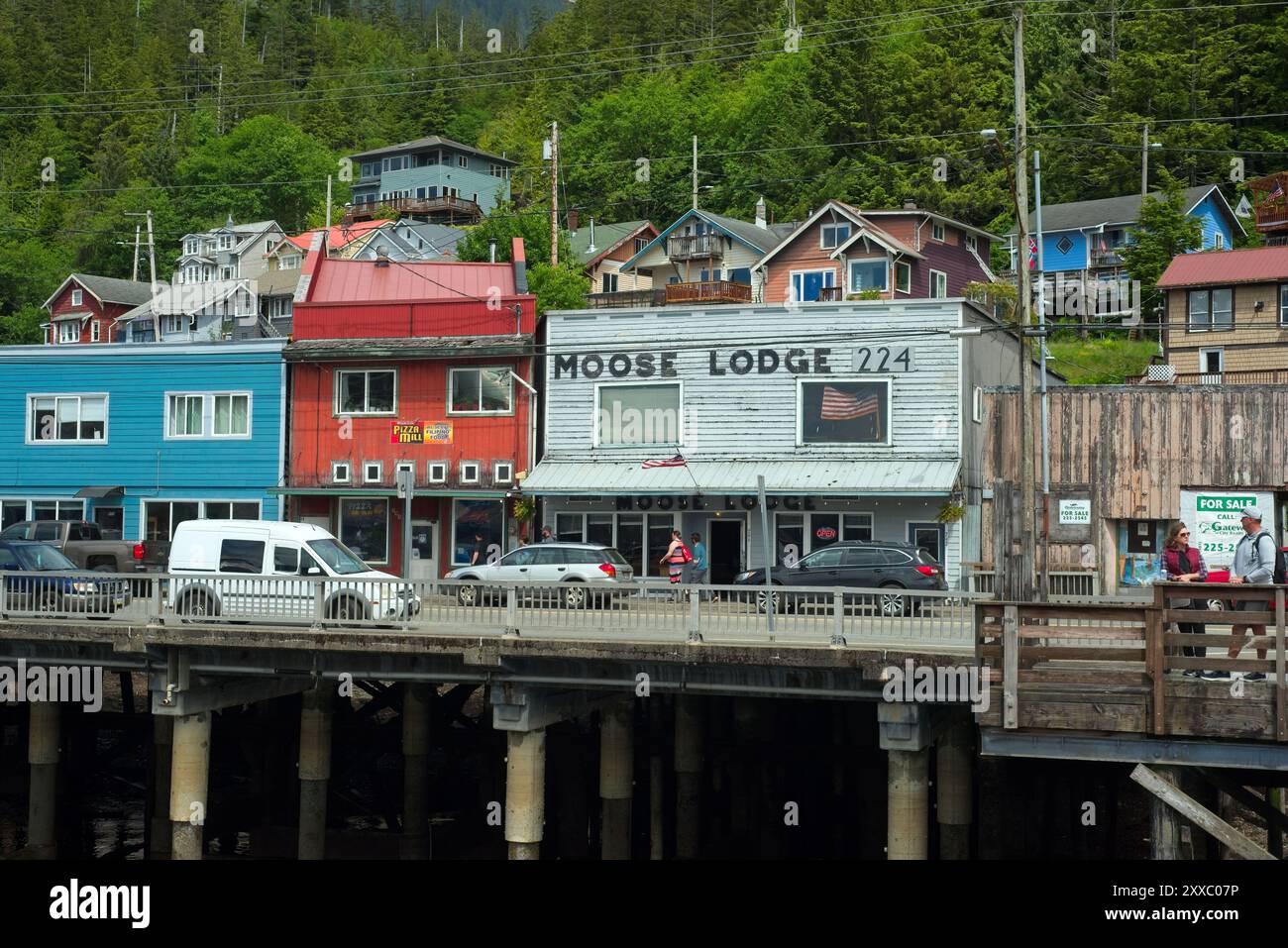 Houses climb the hill above businesses across from the cruise ship ...