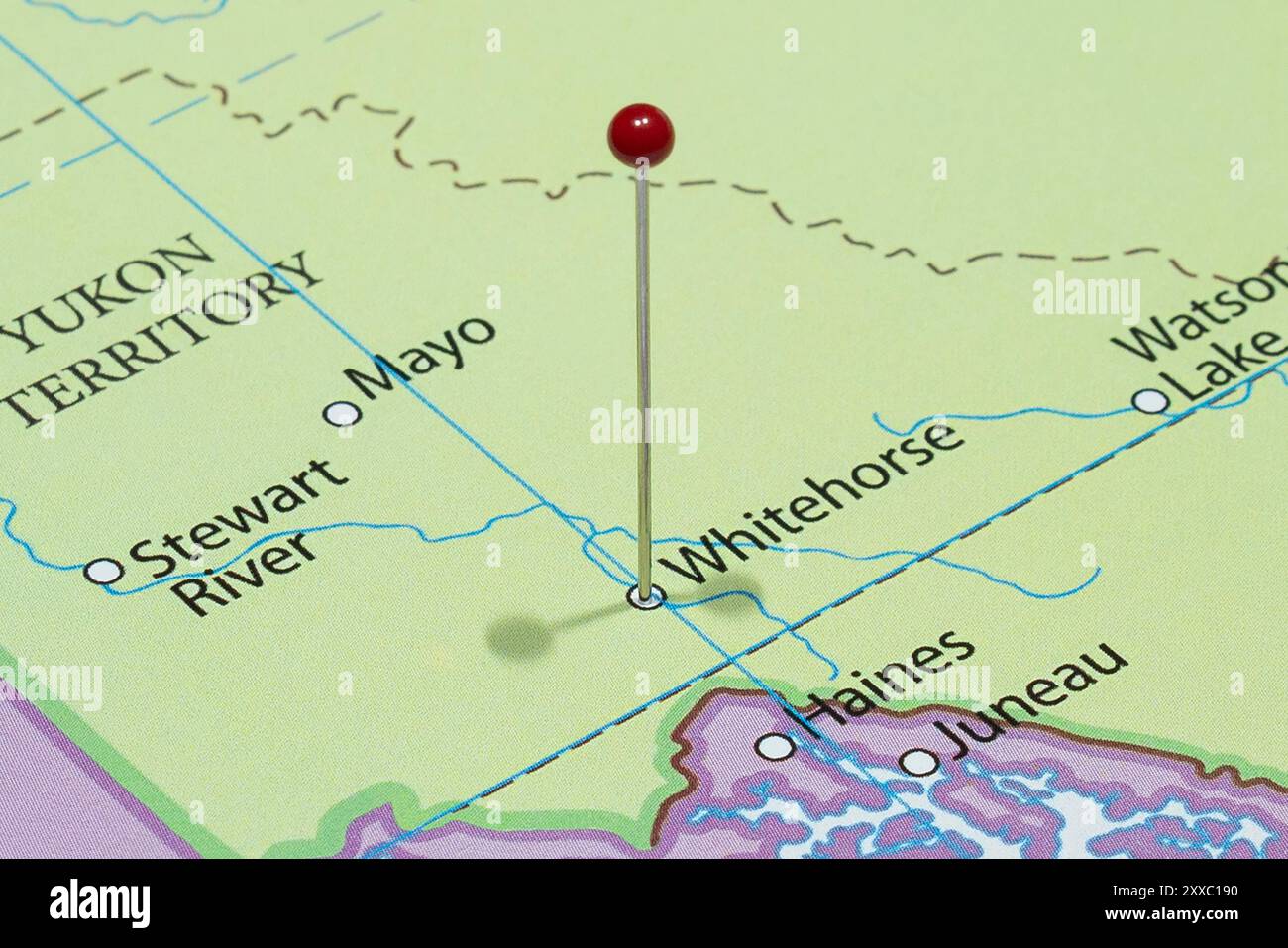 Close up to a Whitehorse with a red pin needle into Canada country ...