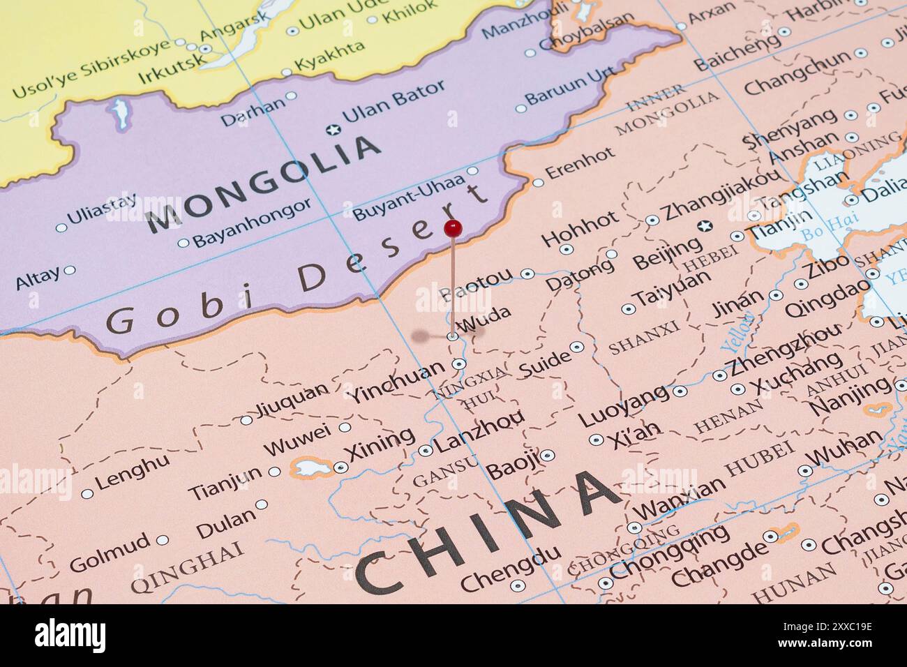 Close up to a Wuda city with a red pin needle into China country ...