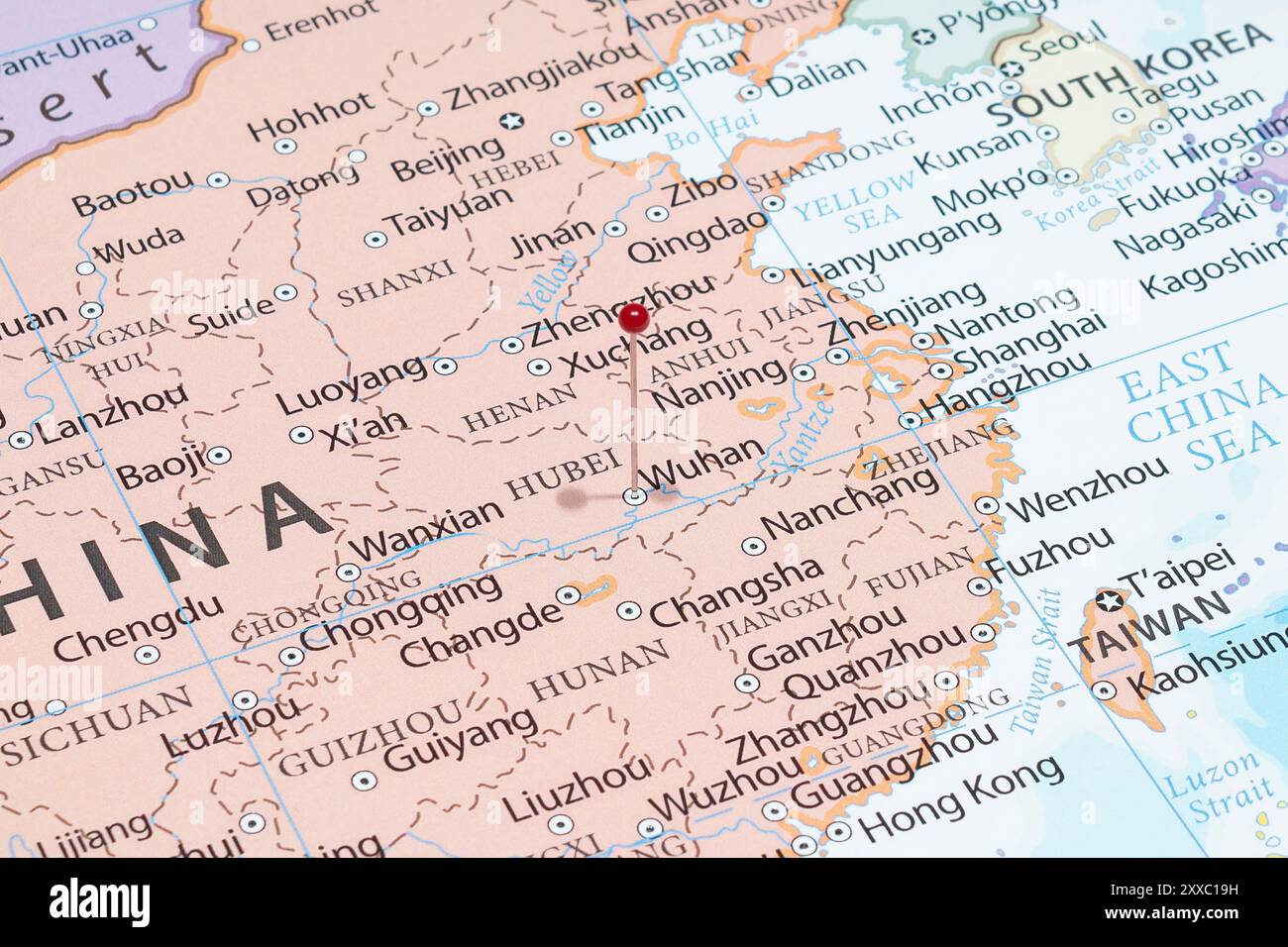 Close up to a Wuhan city with a red pin needle into China country ...