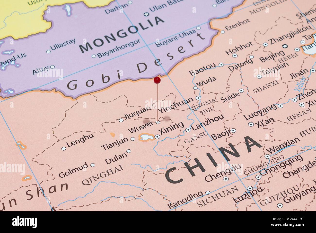 Close up to a Wuwei city with a red pin needle into China country ...