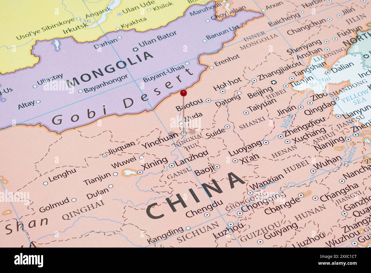 Close up to a Yinchuan city with a red pin needle into China country ...