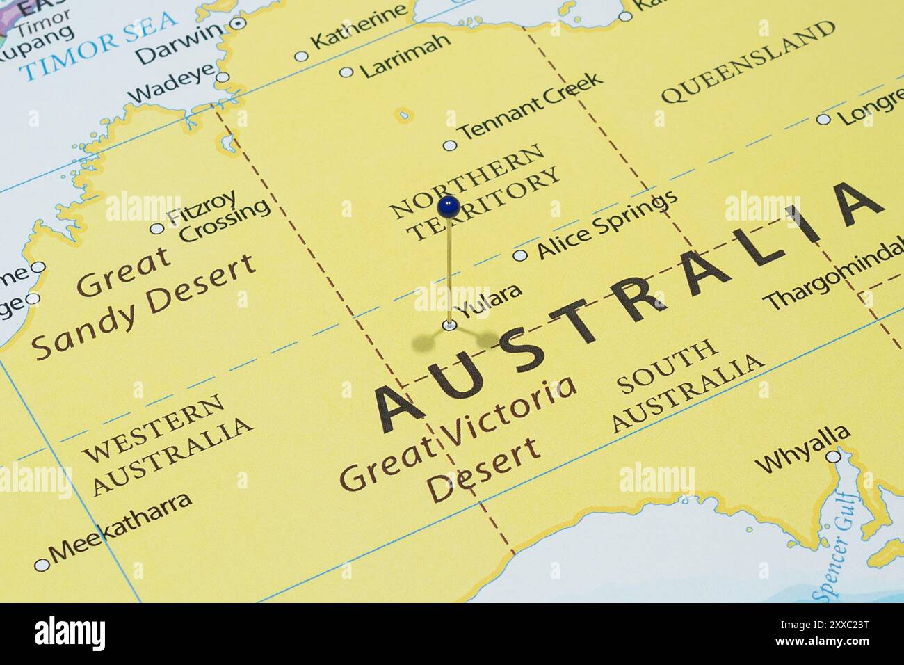 Close up to a Yulara city with a blue pin needle into Australia country ...