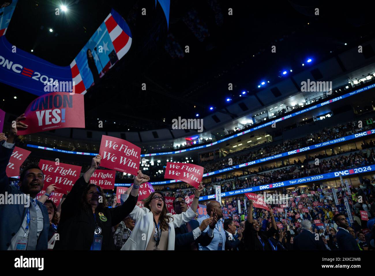 Chicago, United States Of America. 19th Aug, 2024. DNC attendees hold ...