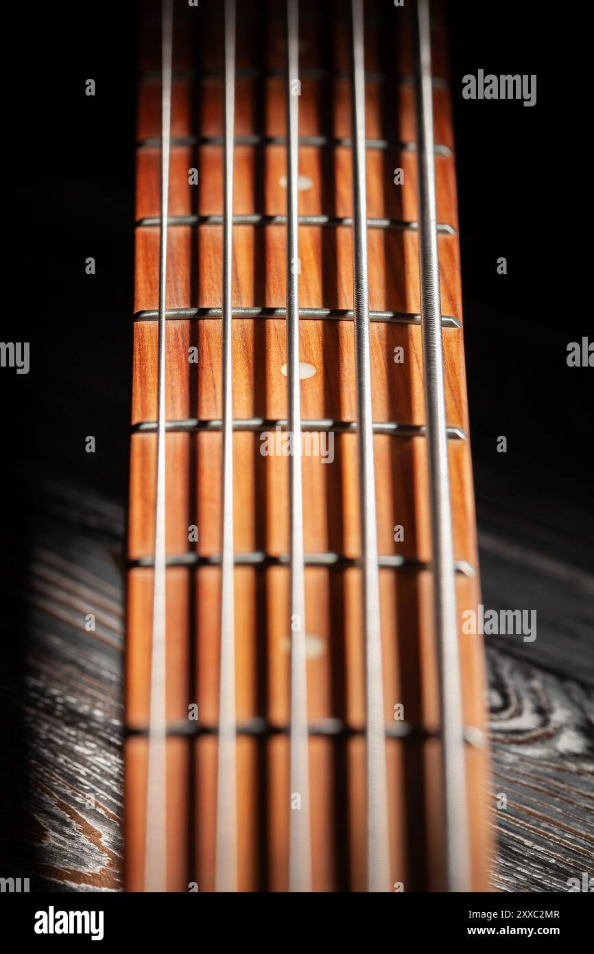 bass guitar fretboard on wood background Stock Photo - Alamy