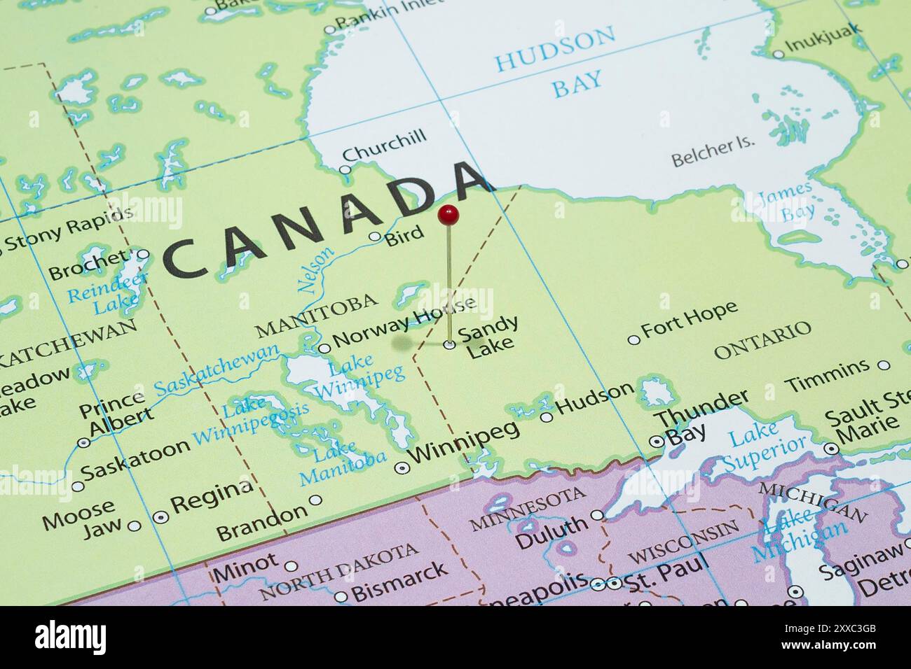 Close up to a Sandy Lake with a red pin needle into Canada country ...