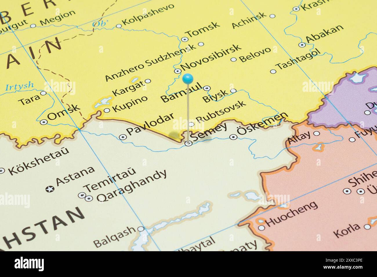 Close up to a Semey city with a light blue pin needle into Kazakhstan ...