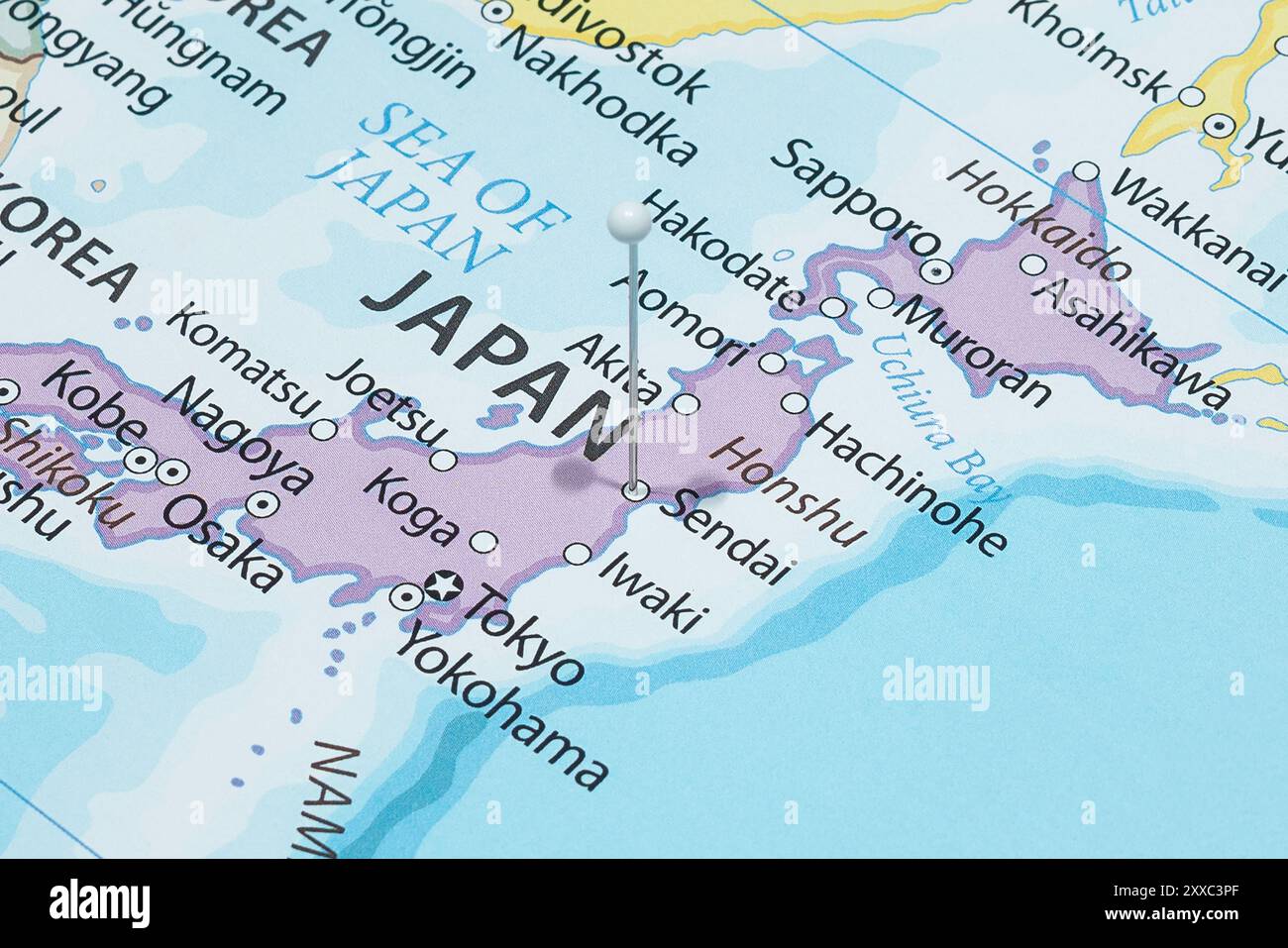 Close up to a Sendai city with a white pin needle into Japan country ...