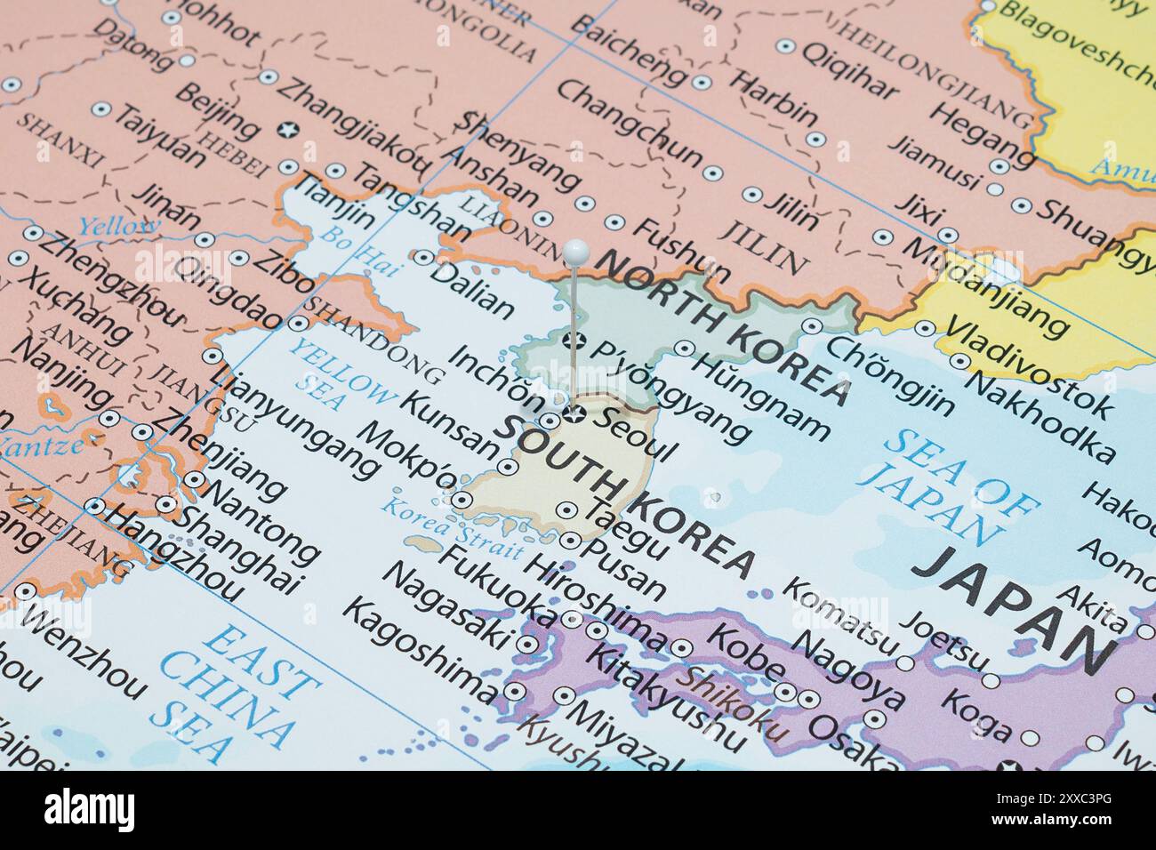 Close up to a Seoul city with a white blue pin needle into South Korea ...