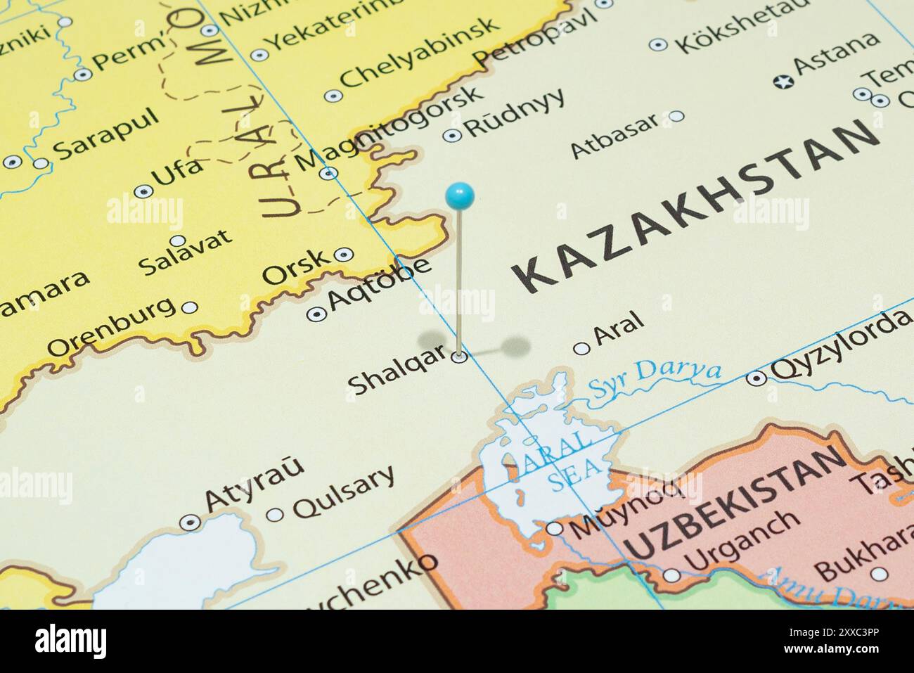 Close up to a Shalkar city with a light blue pin needle into Kazakhstan ...