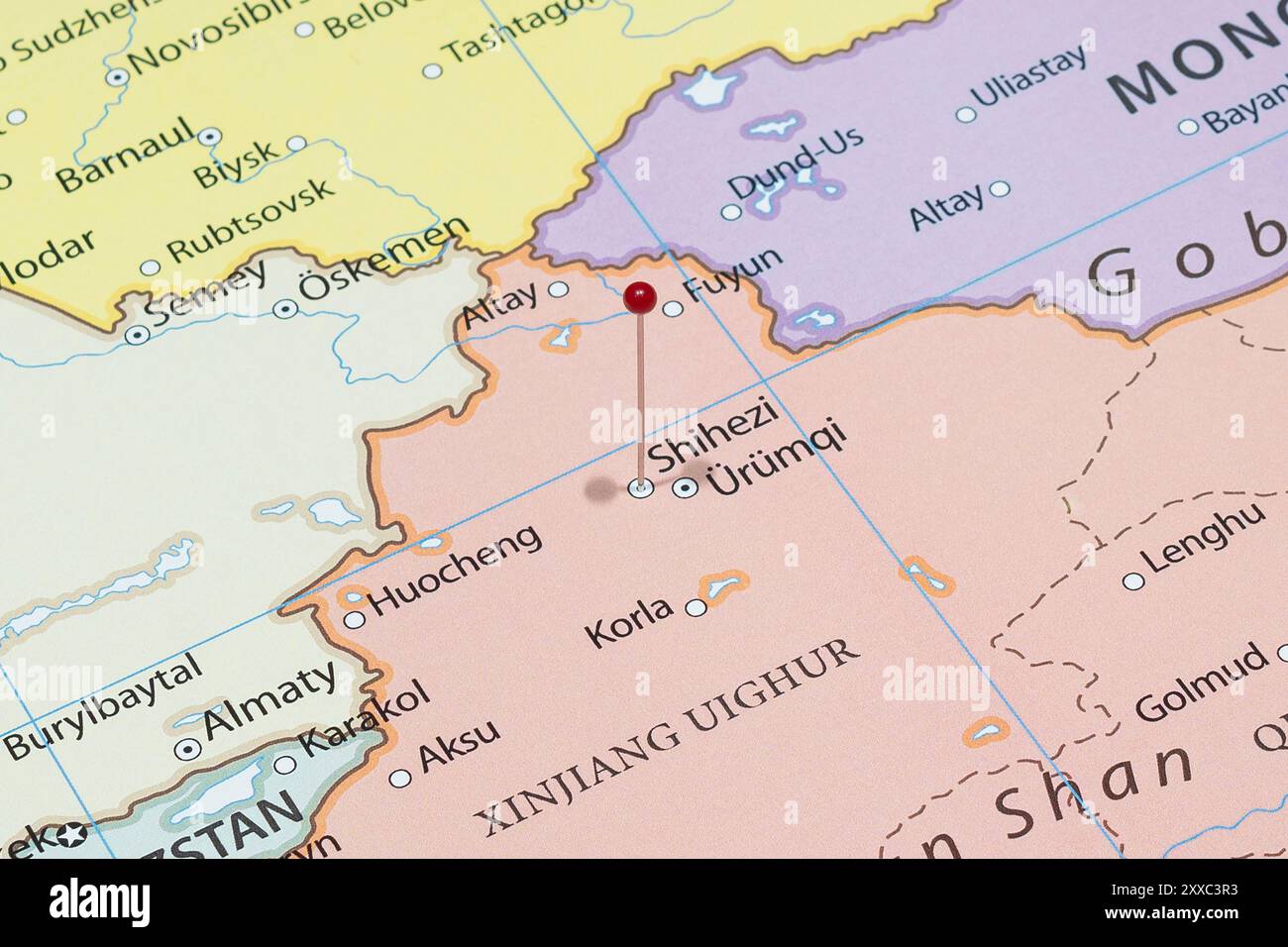Close up to a Shihezi city with a red pin needle into China country ...