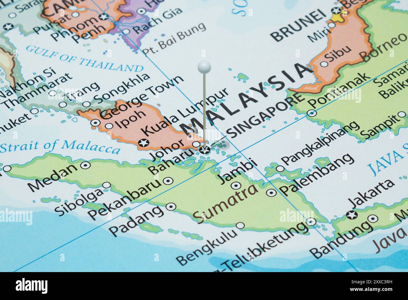 Close up to a Singapore city with a white pin needle into Singapore ...