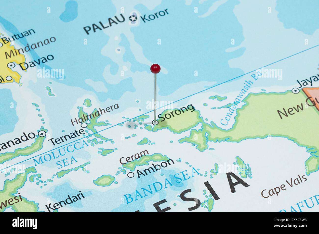 Close up to a Sorong city with a red pin needle into Indonesia country ...