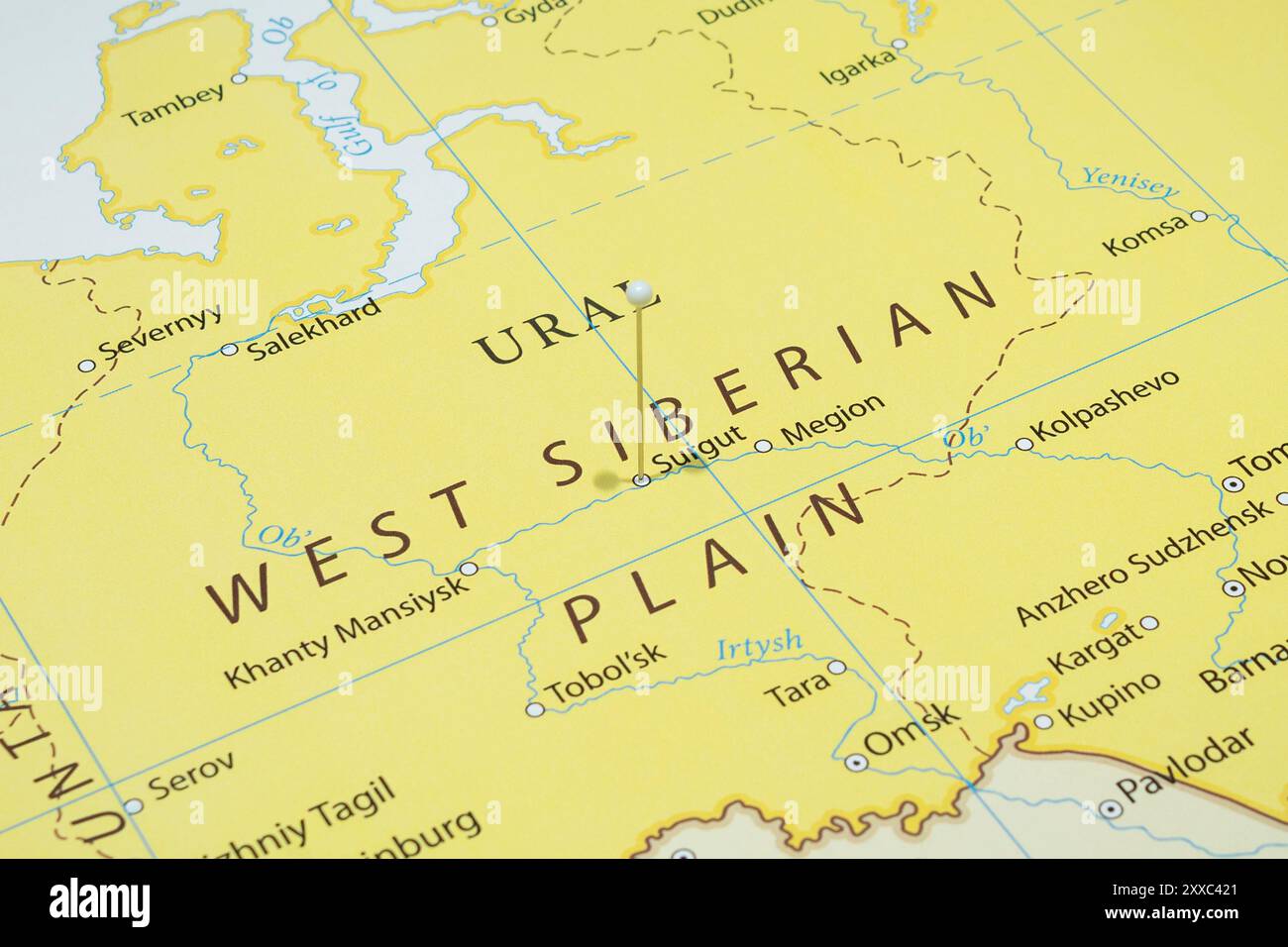 Close up to a Surgut city with a white pin needle into Russia country ...