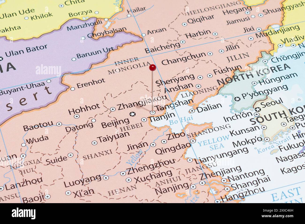 Close up to a Tangshan city with a red pin needle into China country ...