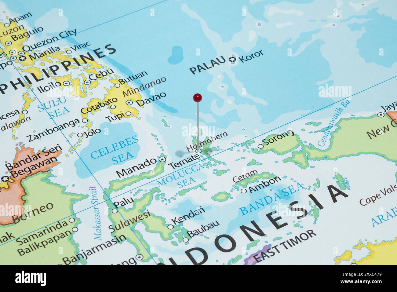 Close up to a Ternate city with a red pin needle into Indonesia country ...