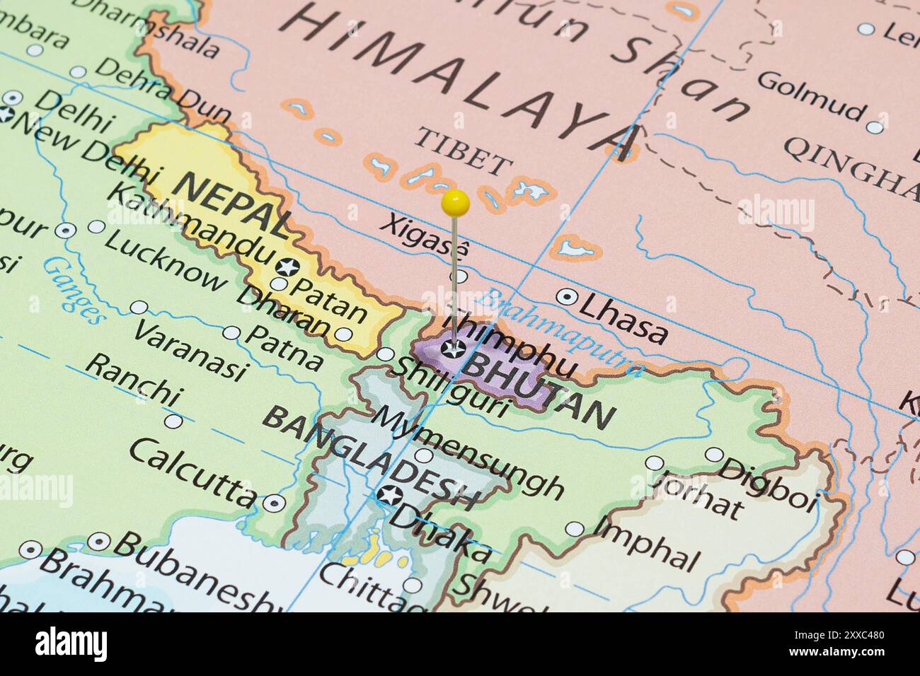 Close up to a Thimphu city with a yellow pin needle into Bhutan country ...