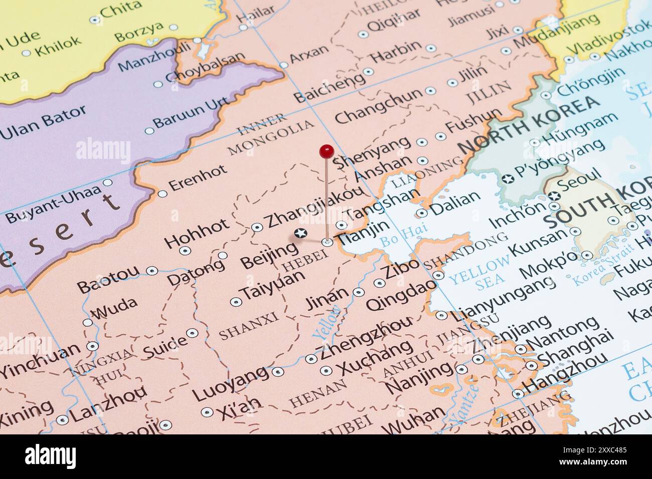 Close up to a Tianjin city with a red pin needle into China country ...