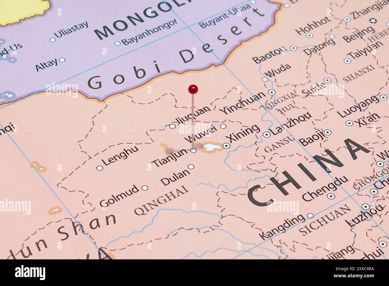 Close up to a Tianjun city with a red pin needle into China country ...