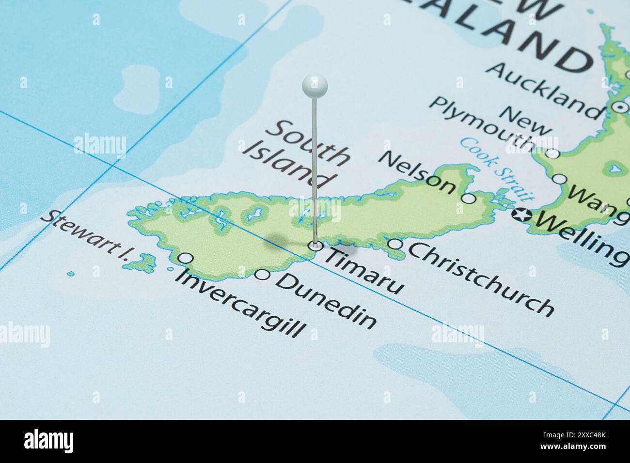 Close up to a Timaru city with a white pin needle into New Zealand ...