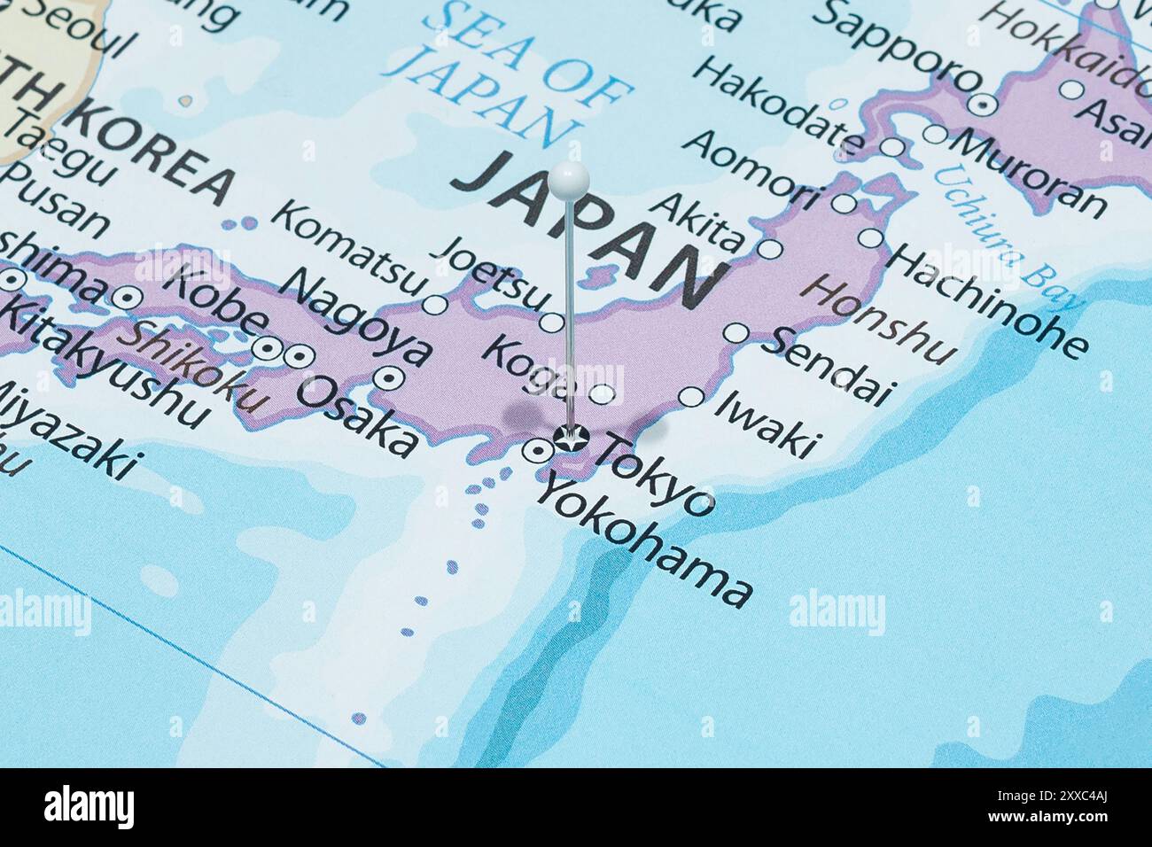 Close up to a Tokyo city with a white pin needle into Japan country ...