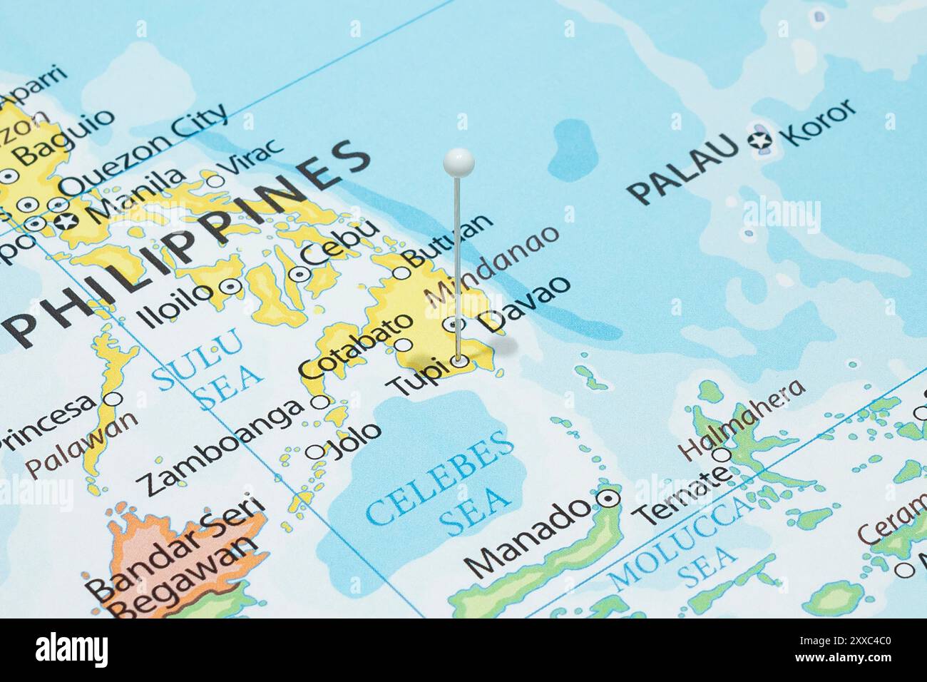 Close up to a Tupi city with a white pin needle into Philippines ...
