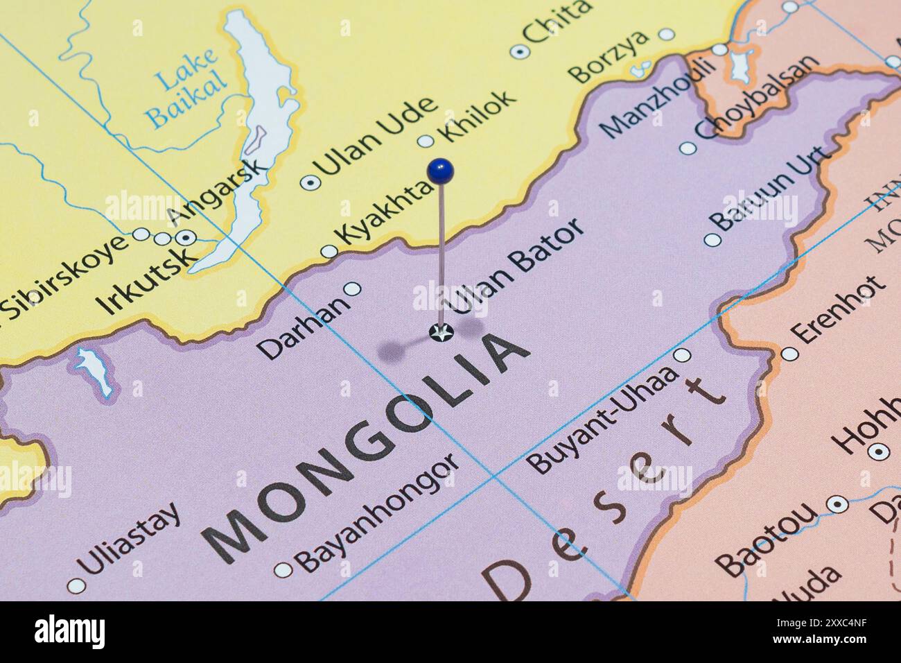 Close up to a Ulan Bator city with a blue pin needle into Mongolia ...