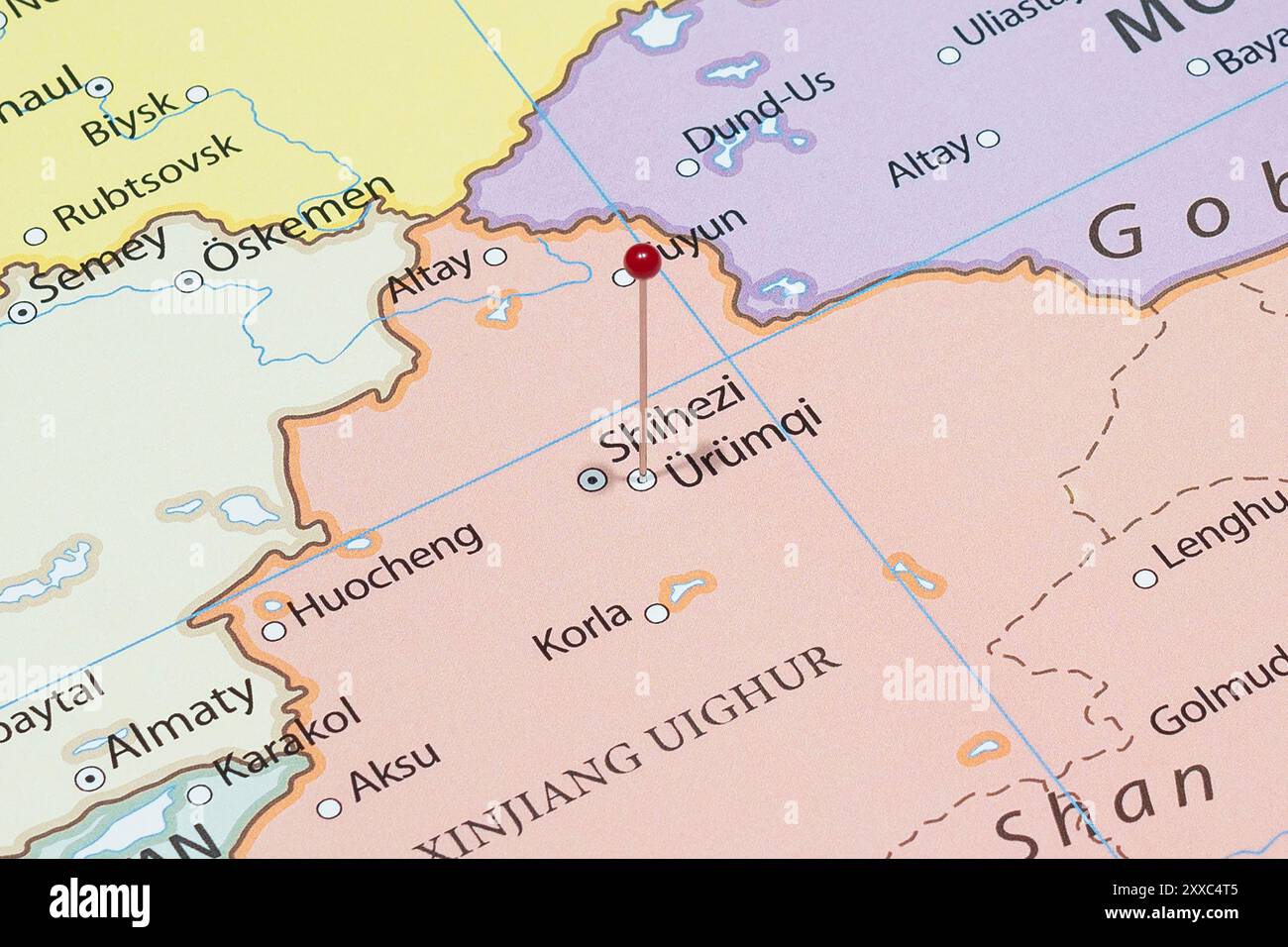 Close up to a Urumqi city with a red pin needle into China country ...