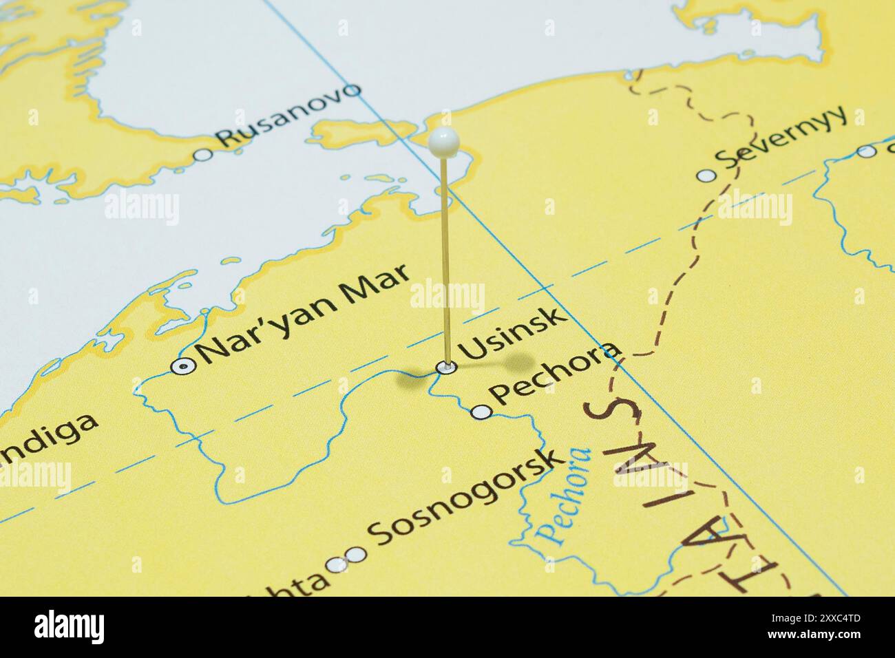 Close up to a Usinsk city with a white pin needle into Russia country ...