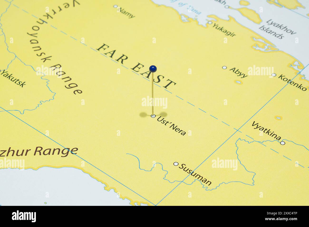 Close up to a Ust Nera city with a blue pin needle into Russia country ...