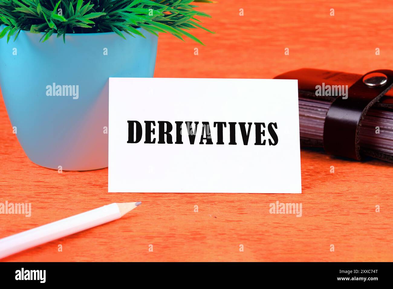 Derivatives word written on a white business card on an orange ...