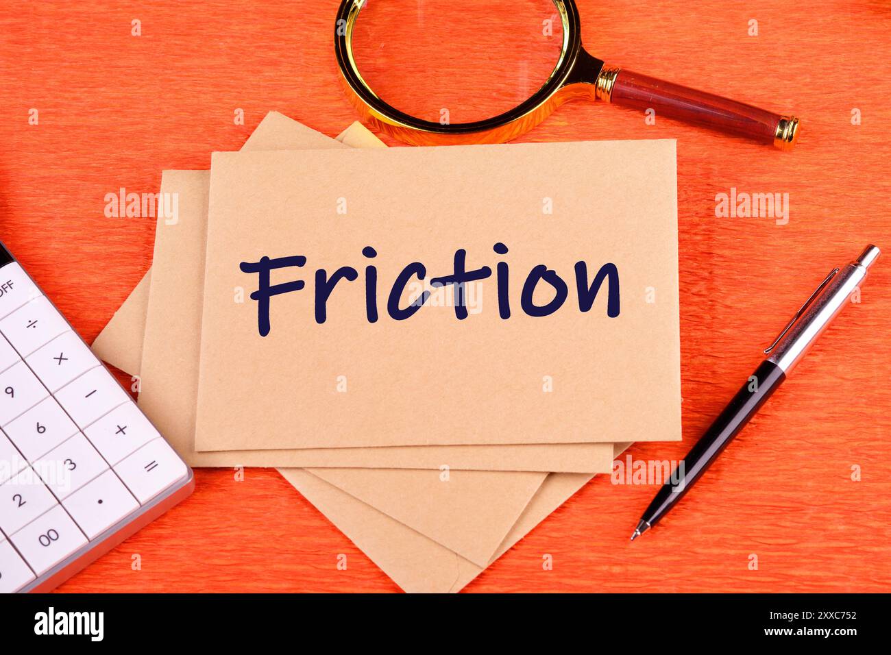 Friction concept. Friction word on postal envelopes on an orange ...