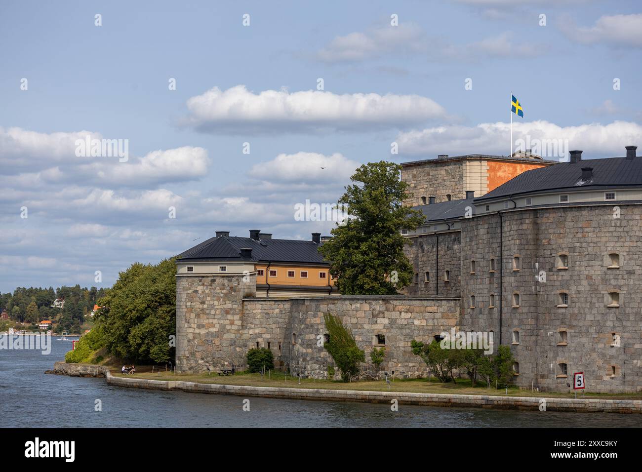 The historic stone fortress "Waxholm" with a Swedish flag flying ...