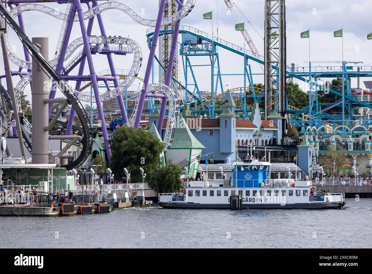 A scenic view of an amusement park featuring roller coasters and a ...
