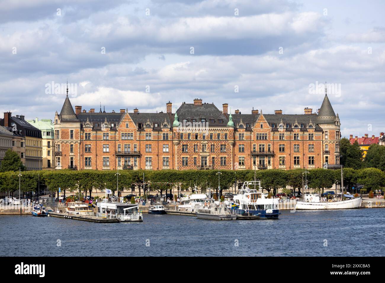 A picturesque view of a historic building along a waterfront, featuring ...