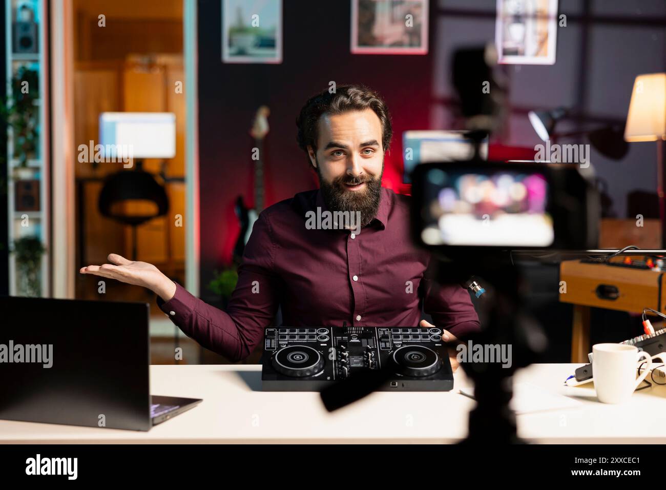 Artist filming DJ mixing tutorial using professional camera, showing ...