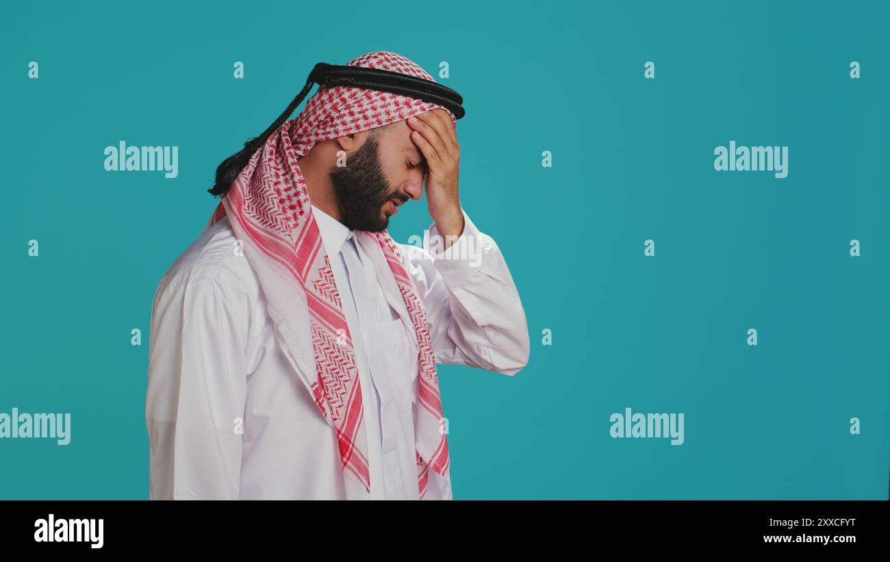 Middle eastern guy dealing with awful headache and tension, suffers ...