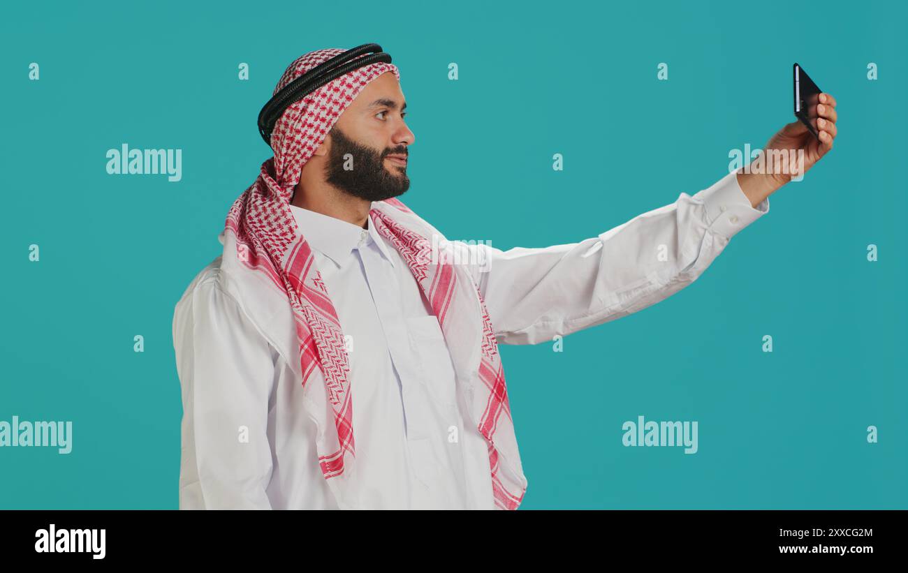 Young arab person takes photos with phone, capturing funny moments on ...